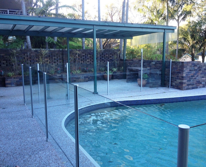 Semi-frameless pool fence. Core drilled into existing pebblecrete.